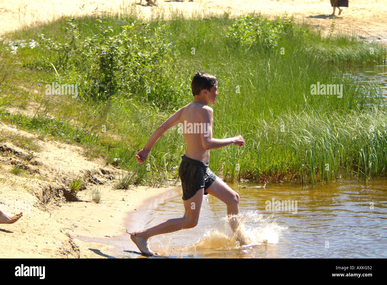 A boy running the water Stock Photo - Alamy