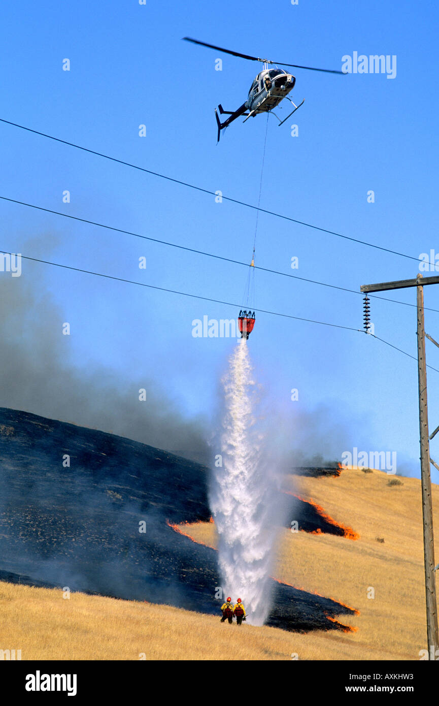A Jet Ranger helicopter dropping water on a wildfire in Idaho Stock ...