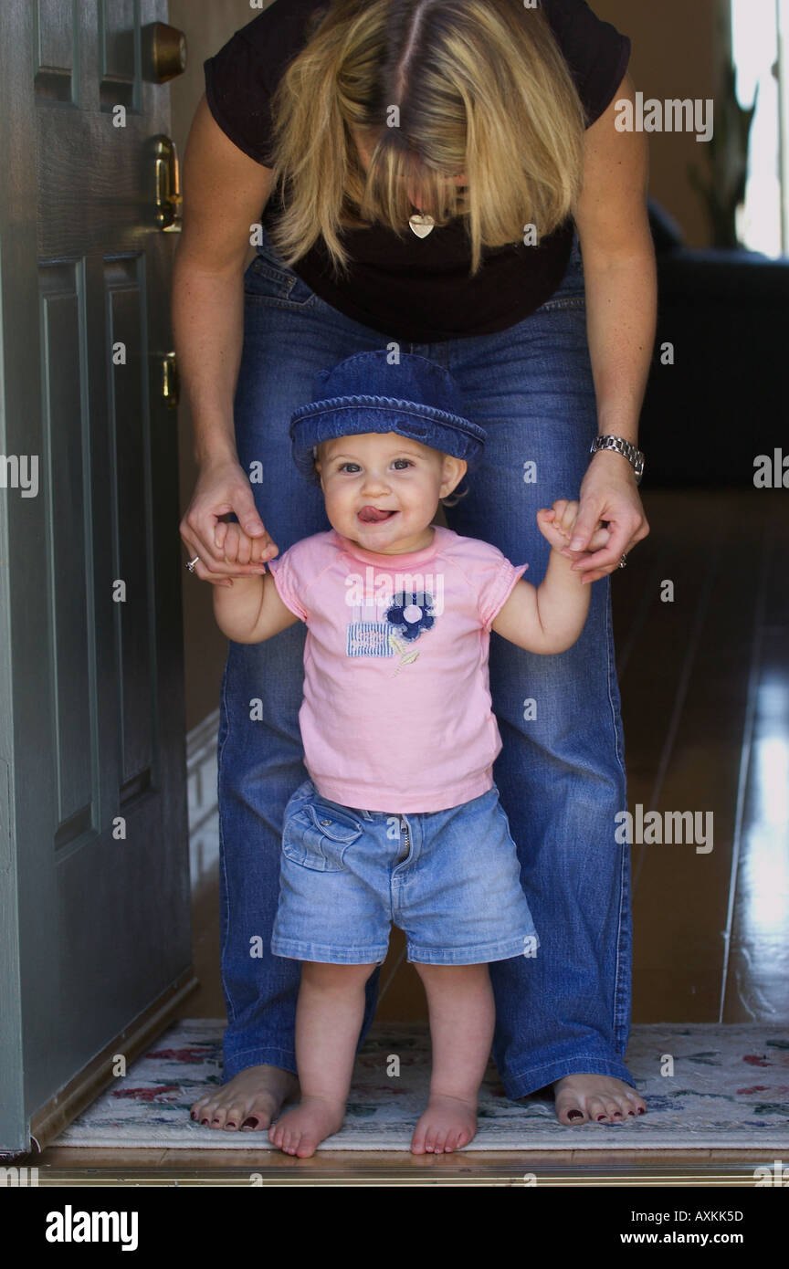 baby standing with mother Stock Photo - Alamy