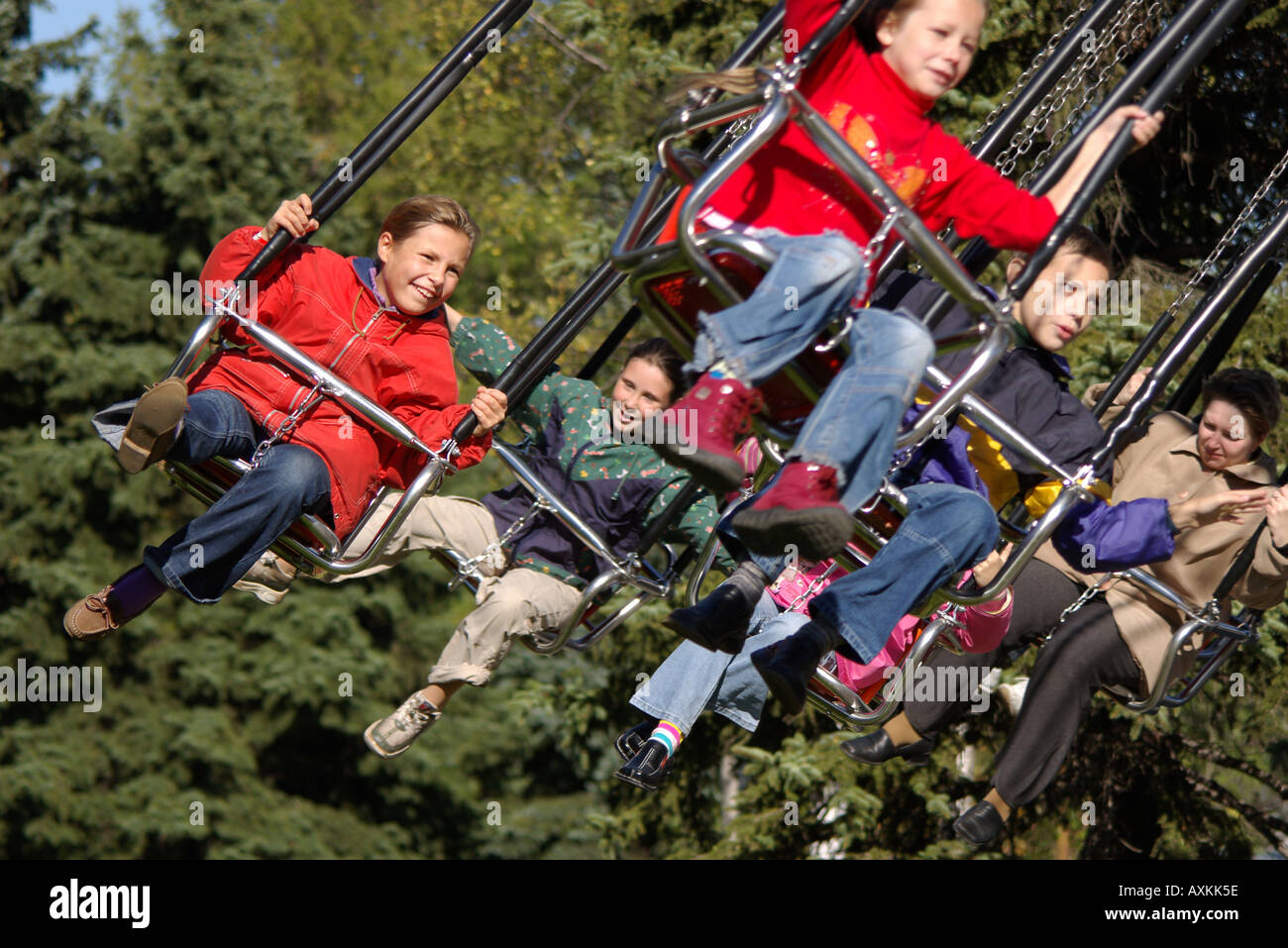 Kids riding merry go round Stock Photo - Alamy