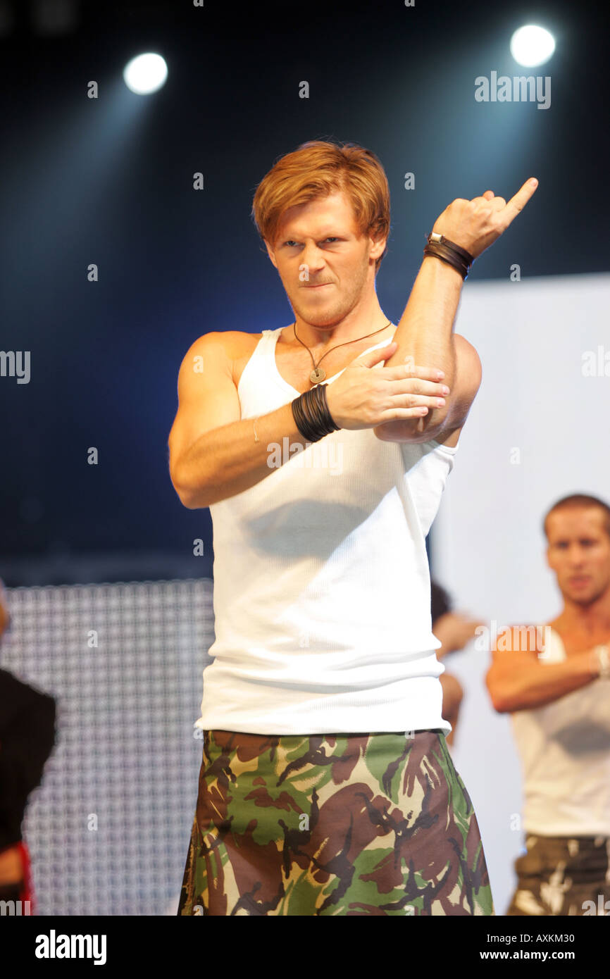 Male model wearing white vest and camouflage kilt at the Clothes Show ...