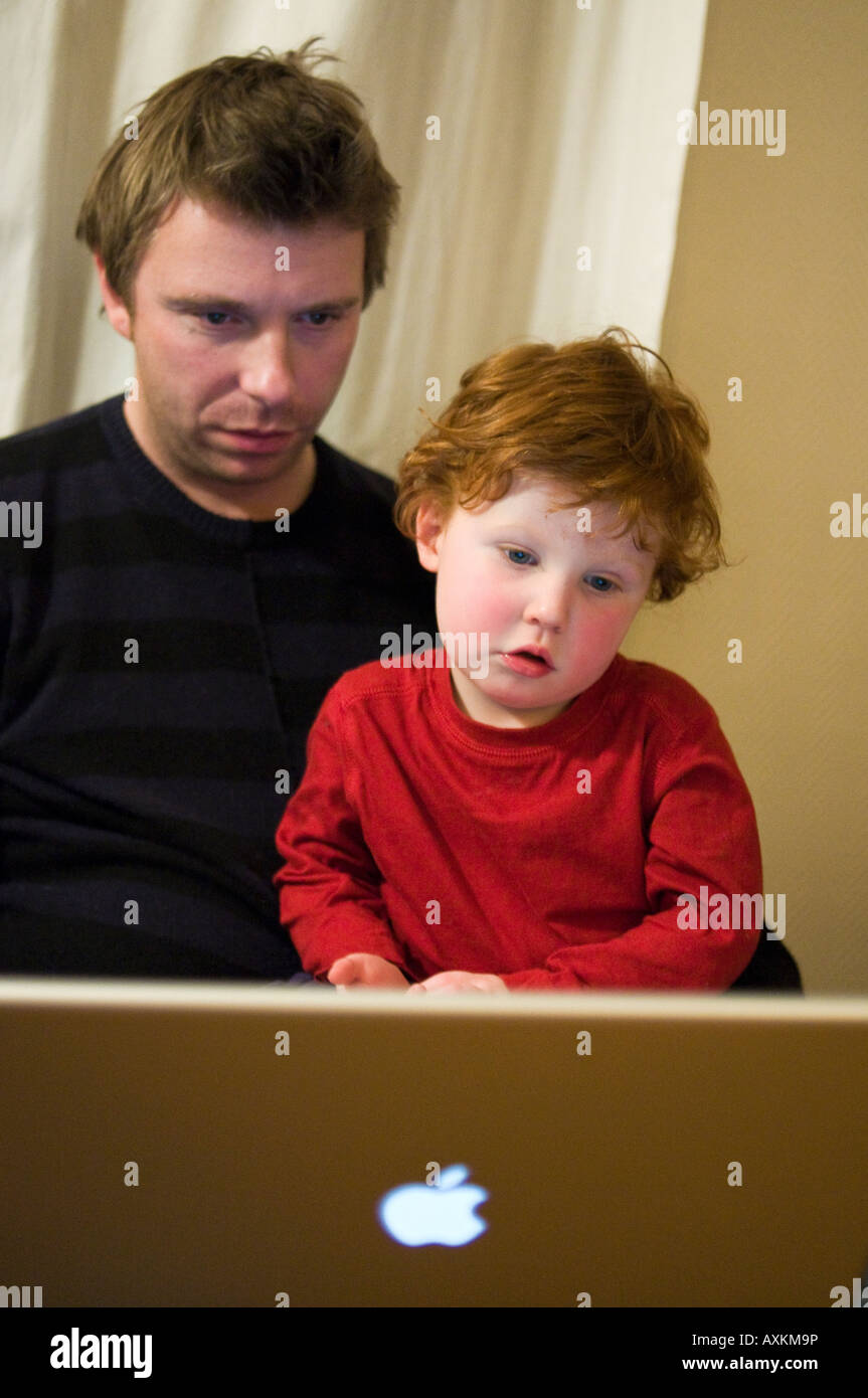 Father and son using a lap top computer Stock Photo - Alamy