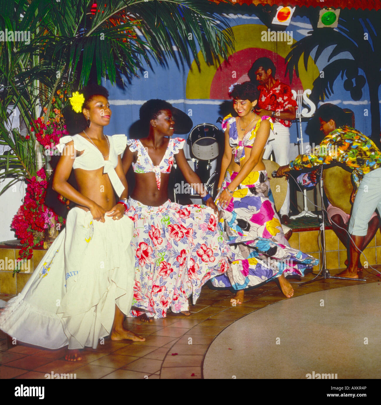 Three girls in red blue yellow flowing dresses with bare midriffs ...