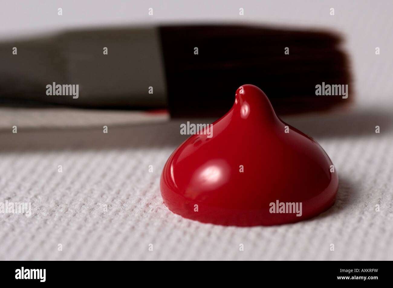 red drop paint on white canvas with brush in background Stock Photo - Alamy