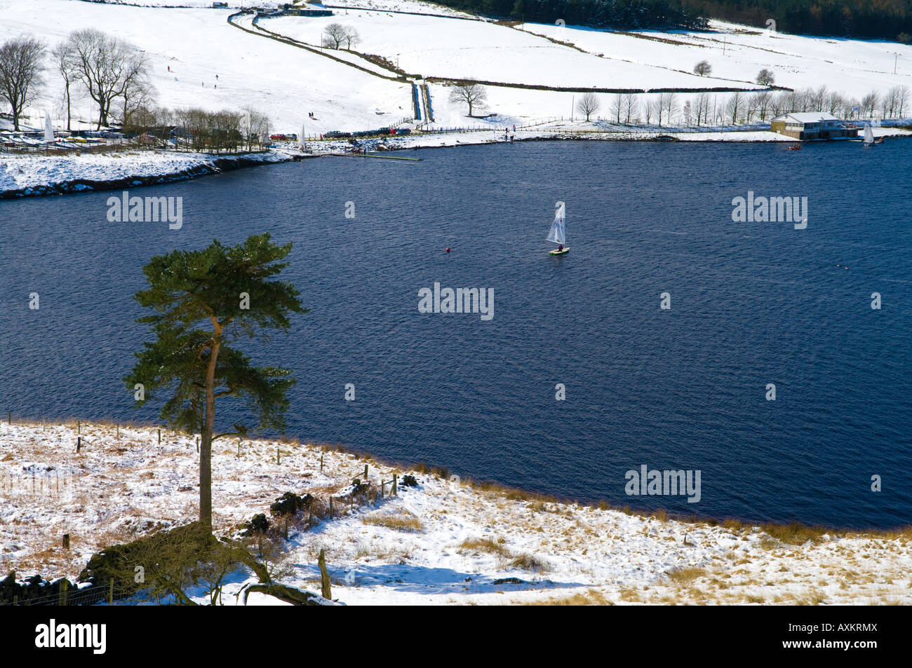 Boat sailing on Dovestones reservoir with snow Stock Photo - Alamy