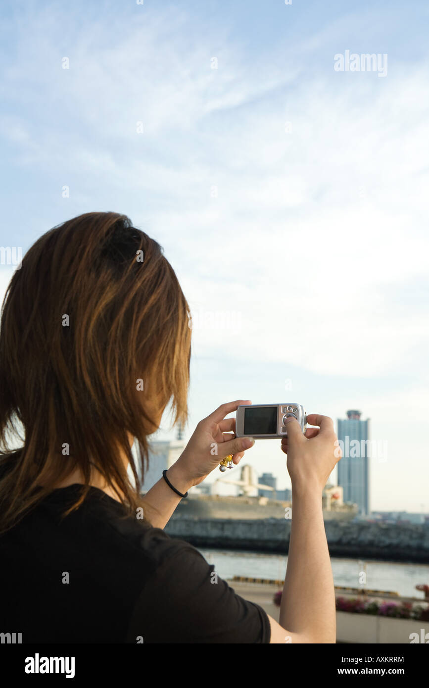 Young man photographing cityscape with digital camera, rear view Stock ...