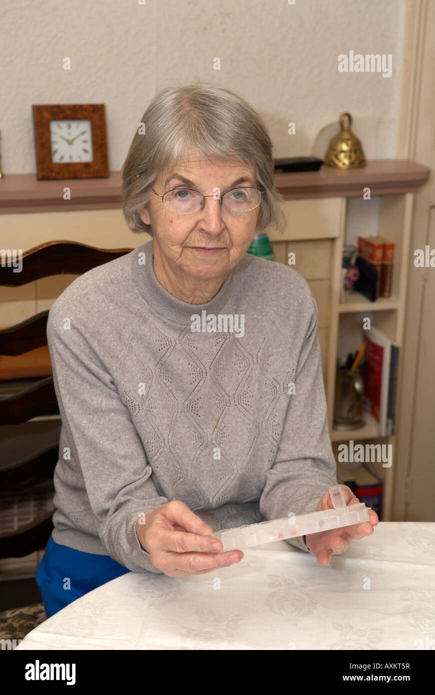 Elderly lady preparing to take her medication at home Stock Photo - Alamy