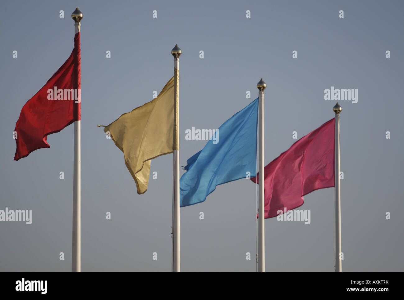 Row of coloured flags flying on poles Stock Photo - Alamy