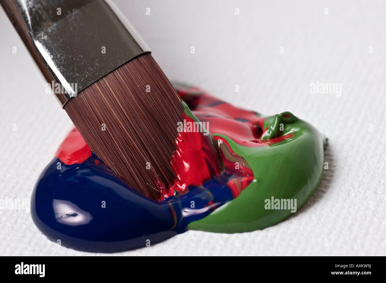 red green and blue paint drops on a canvas with a brush near by Stock ...