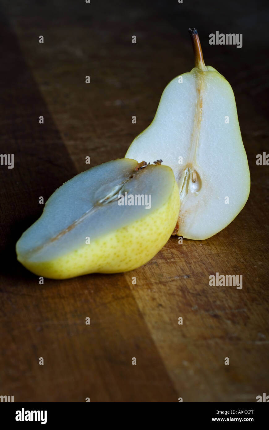 Stock photo of a Pear cut in half on a wooden table Stock Photo - Alamy