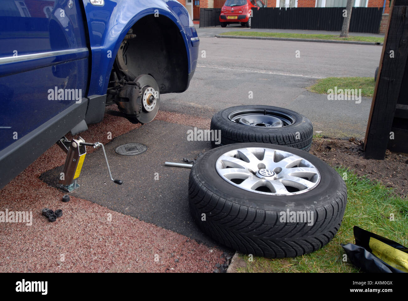 Car having the wheel changed after a puncture Stock Photo - Alamy