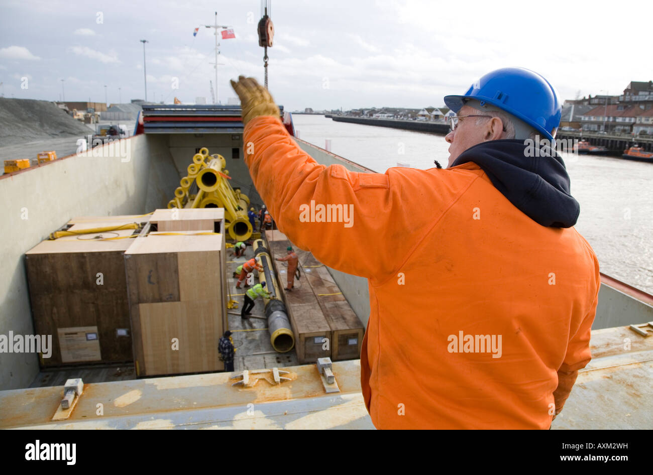 Man hand signals crane operator during loading of container ship Stock ...