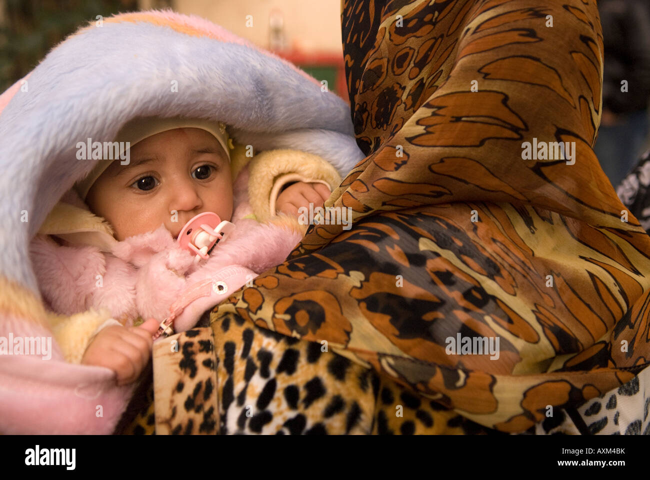 Libyan woman carrying her baby in the Medina or Old Town Tripoli Libya ...