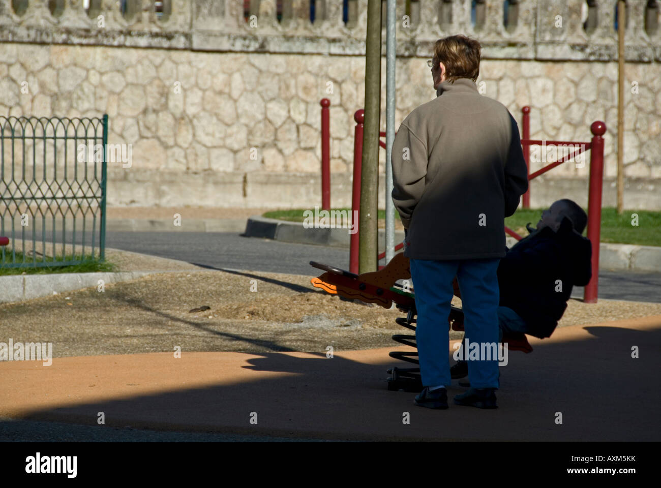 Stock photo of a mum looking disinterested as her child plays on a ...