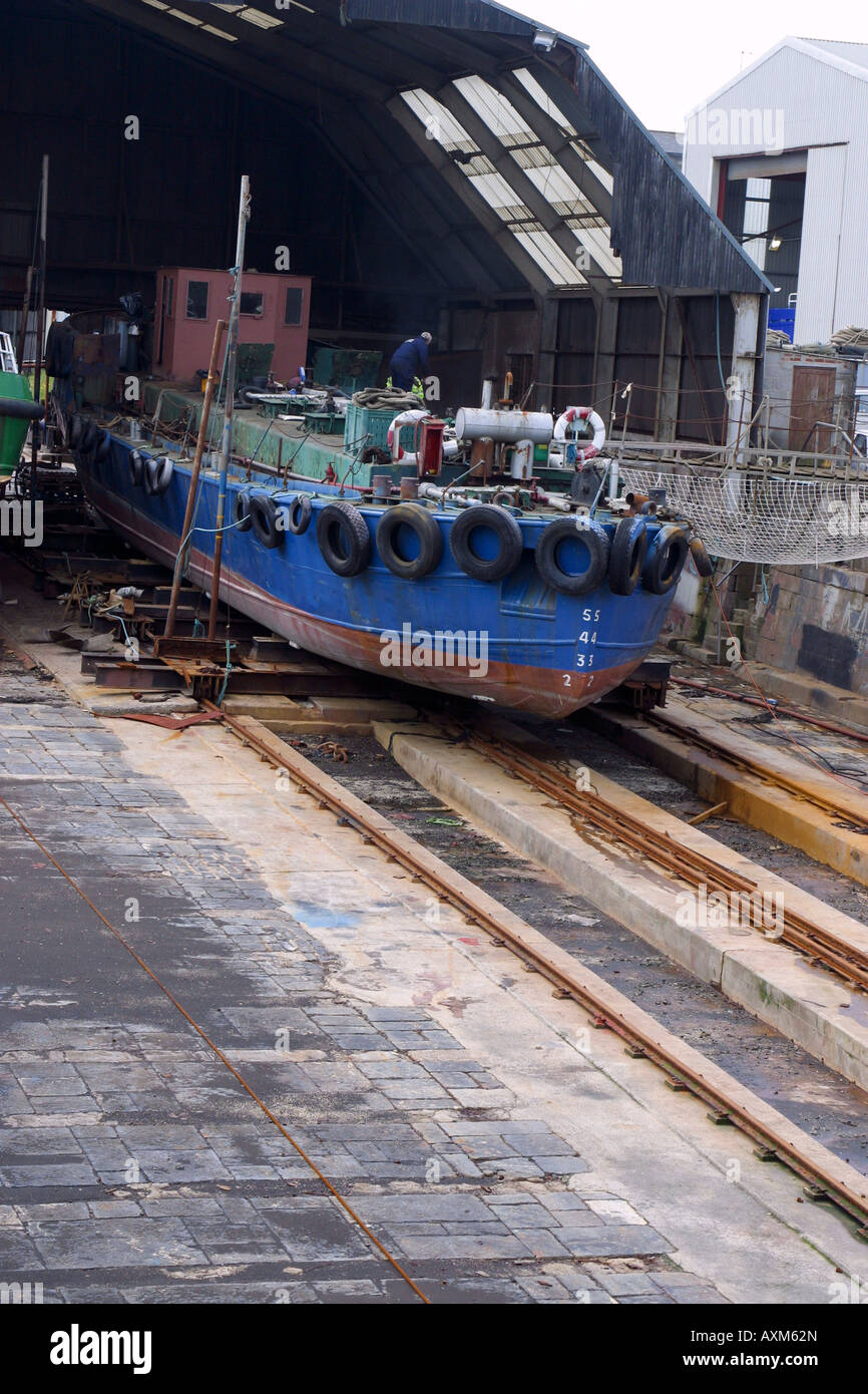 Ship building Pembroke dock. Repair of small trawler / barge on slipway ...