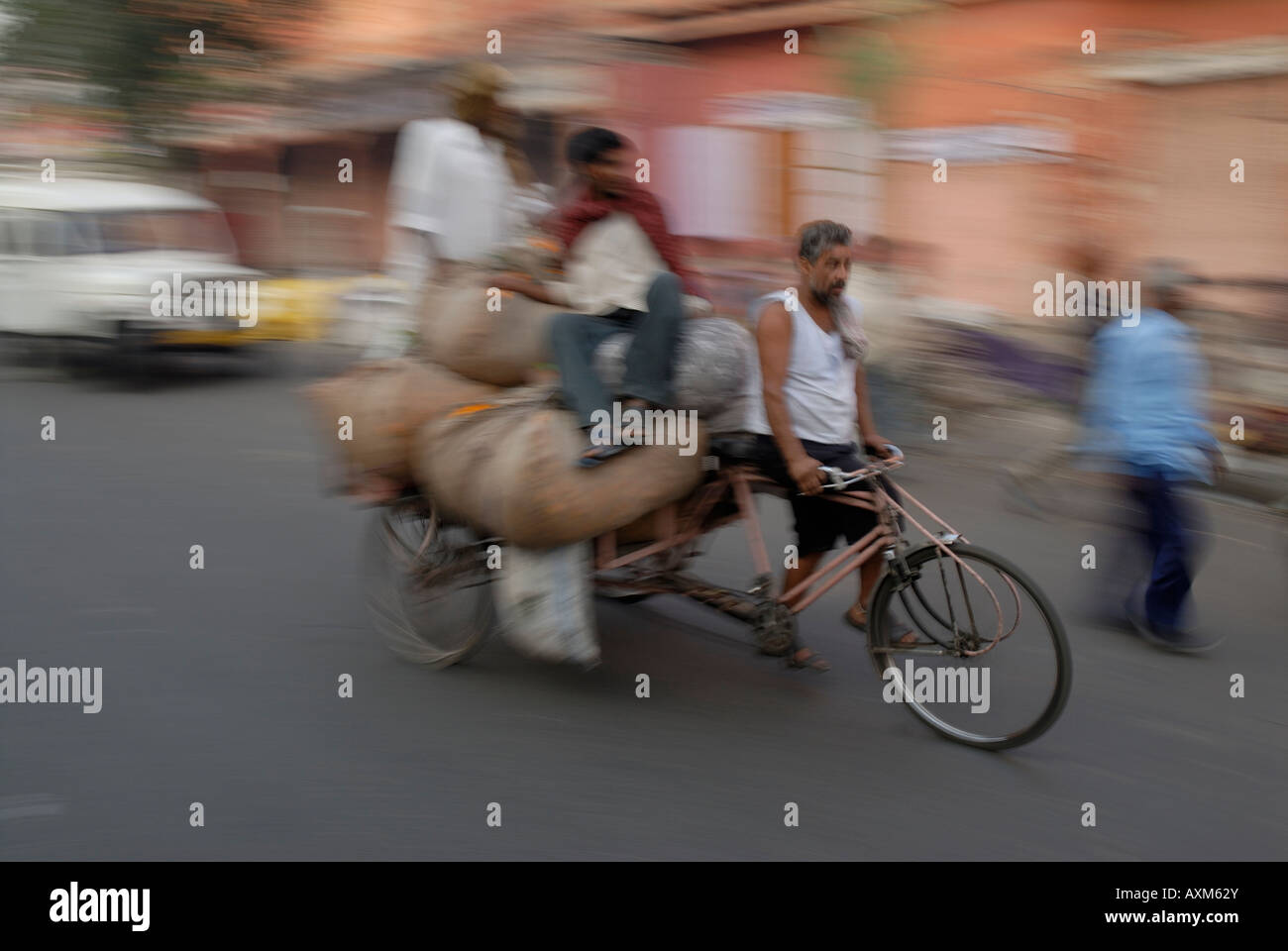 Rickshaw driver loaded with goods and passengers in Jaipur Rajasthan ...