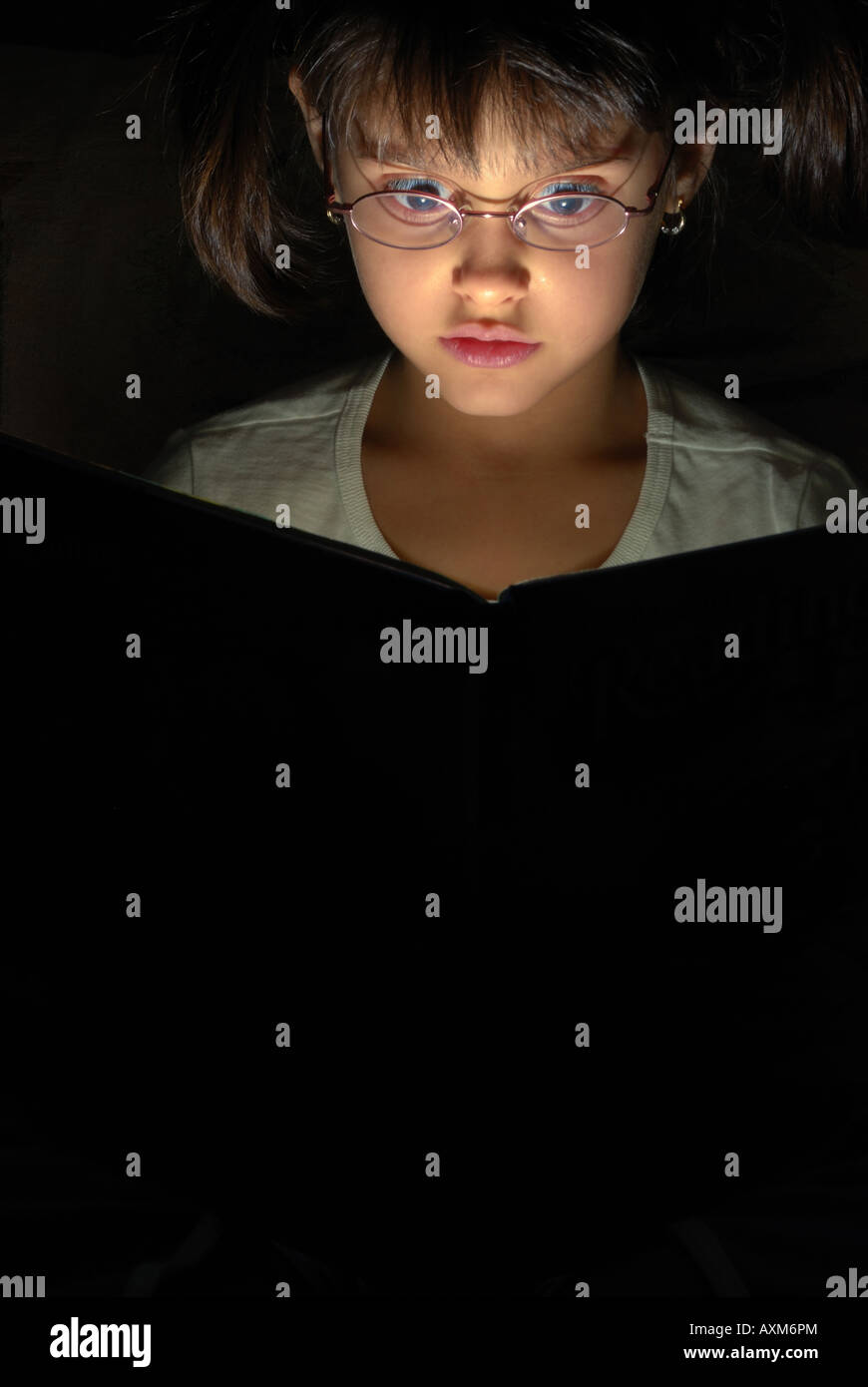 Girl Reading Magic Book Stock Photo - Alamy