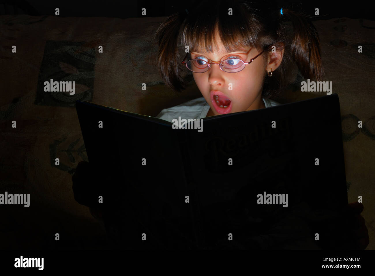 Girl Reading Scary Book Stock Photo - Alamy