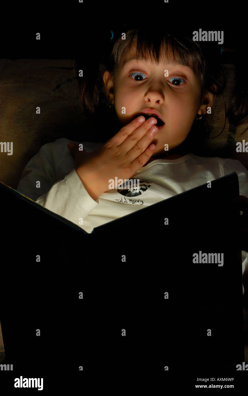 Girl Reading Magic Book Stock Photo - Alamy