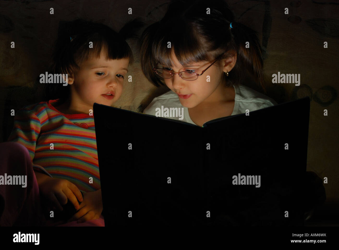 Girls Reading Magic Book Stock Photo - Alamy