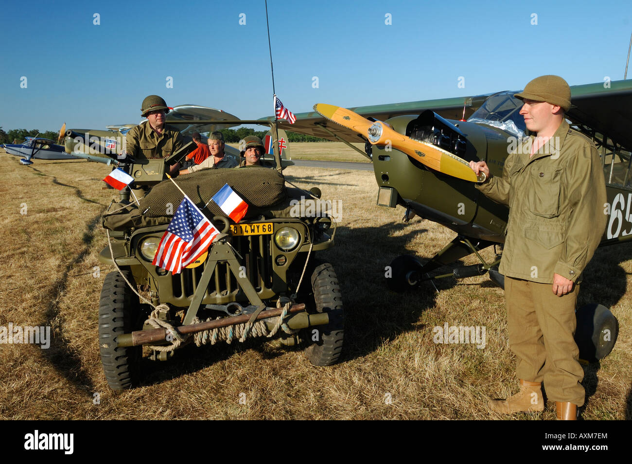 WWII, re enactment of US soldiers with typical Jeep car and Piper J-3 ...