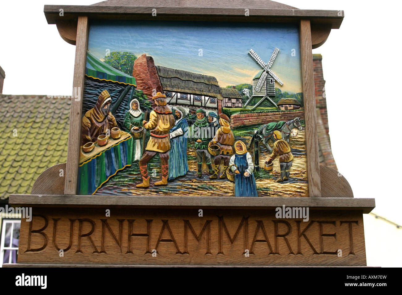 Norfolk Burnham Market village sign showing medieval market traders on ...