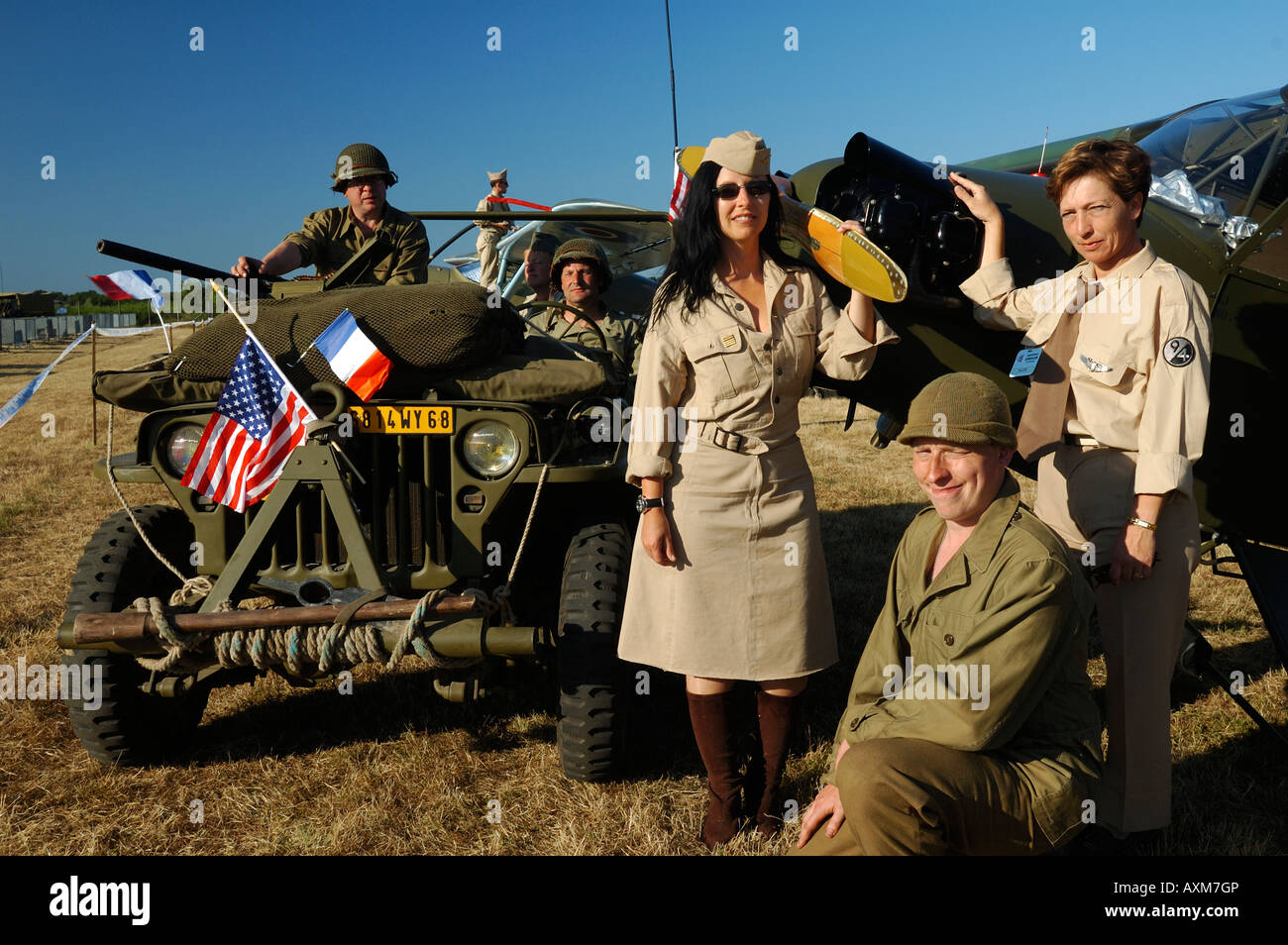 WWII, re enactment of US soldiers with typical Jeep car and Piper J-3 ...
