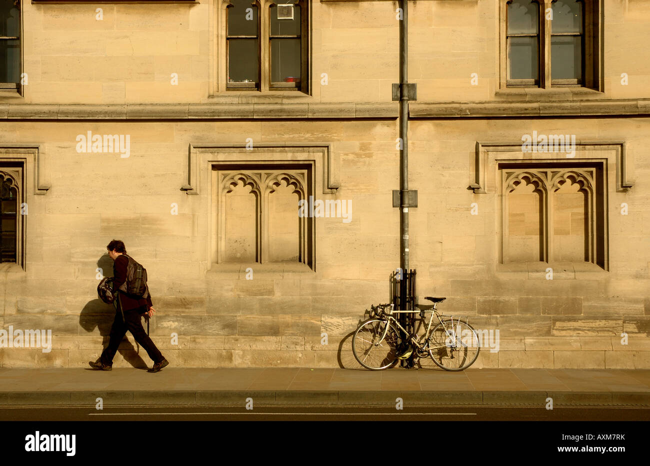man walking past university building in oxford Stock Photo - Alamy