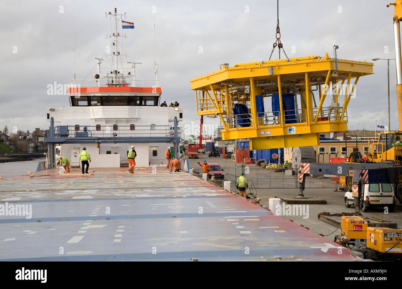 Loading crew aboard a container ship watch as rig structure is lifted ...