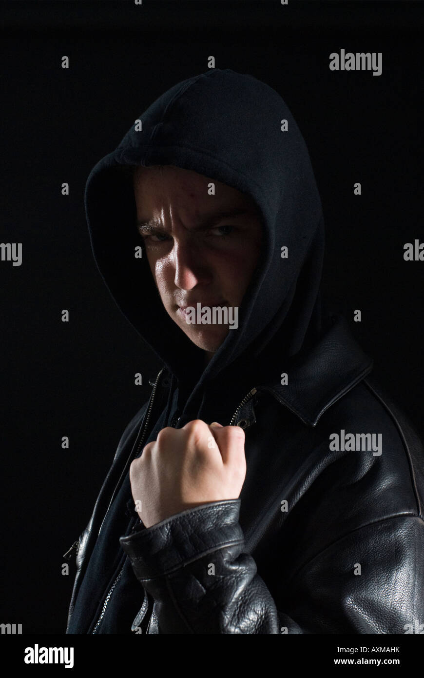 Teenage lout threatening with fist Stock Photo - Alamy