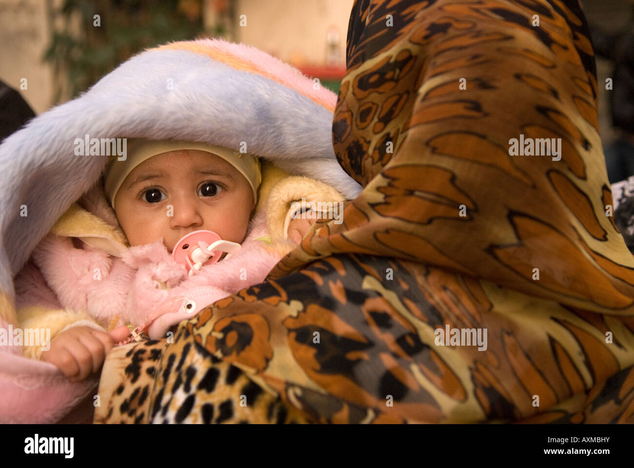 Libyan woman carrying her baby in the Medina or Old Town Tripoli Libya ...