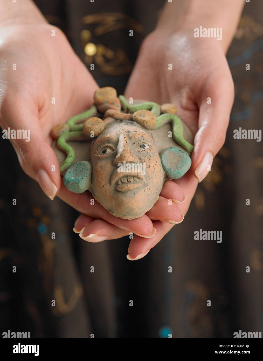 Hand holding face sculpture hi-res stock photography and images - Alamy