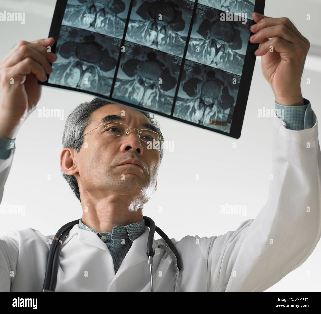 Male doctor looking at x rays Stock Photo - Alamy