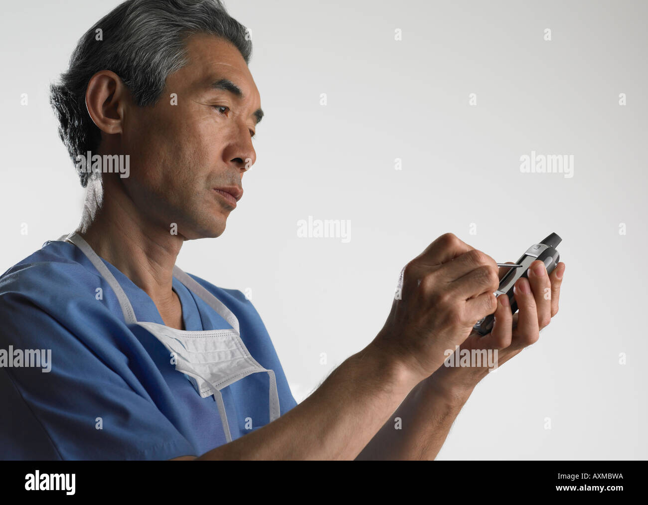 Studio shot of male doctor using PDA Stock Photo - Alamy