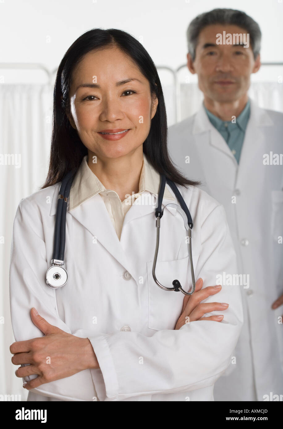 Asian female and male doctors smiling Stock Photo - Alamy
