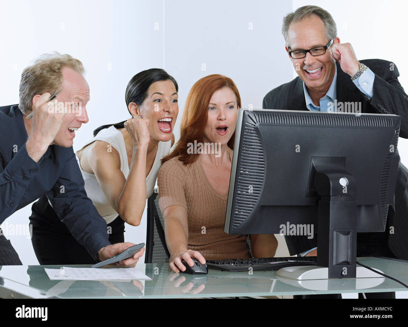 Group of businesspeople cheering with computer Stock Photo - Alamy