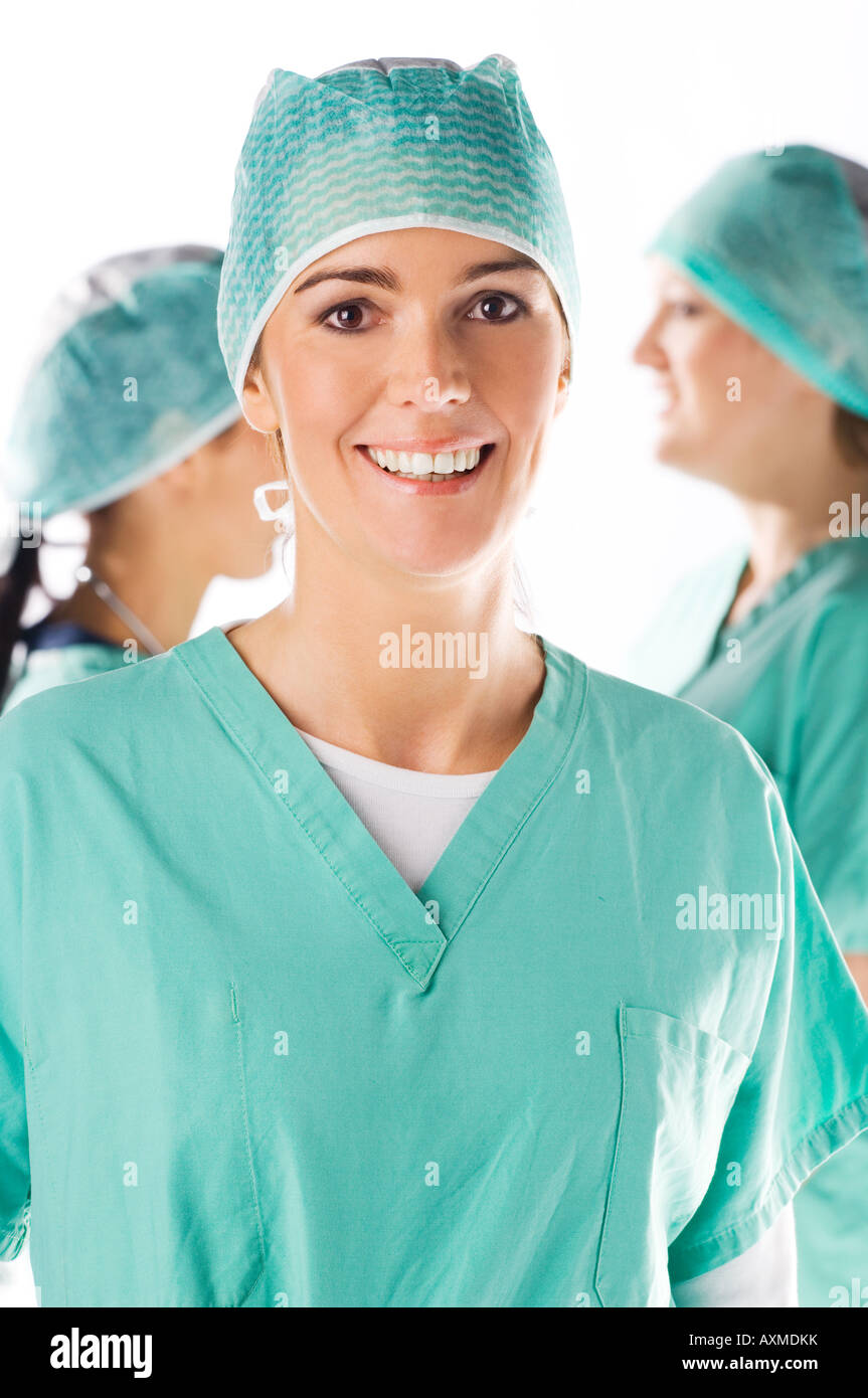Beautiful young nurse smiling with her team in the background Stock ...