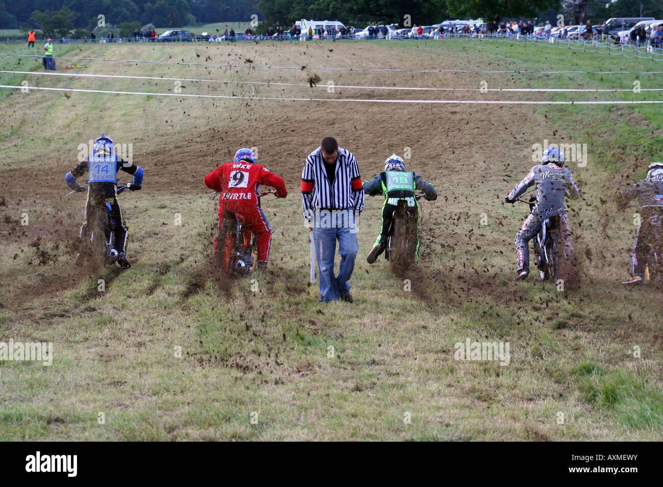 Race official does his best to avoid flying mud Stock Photo - Alamy