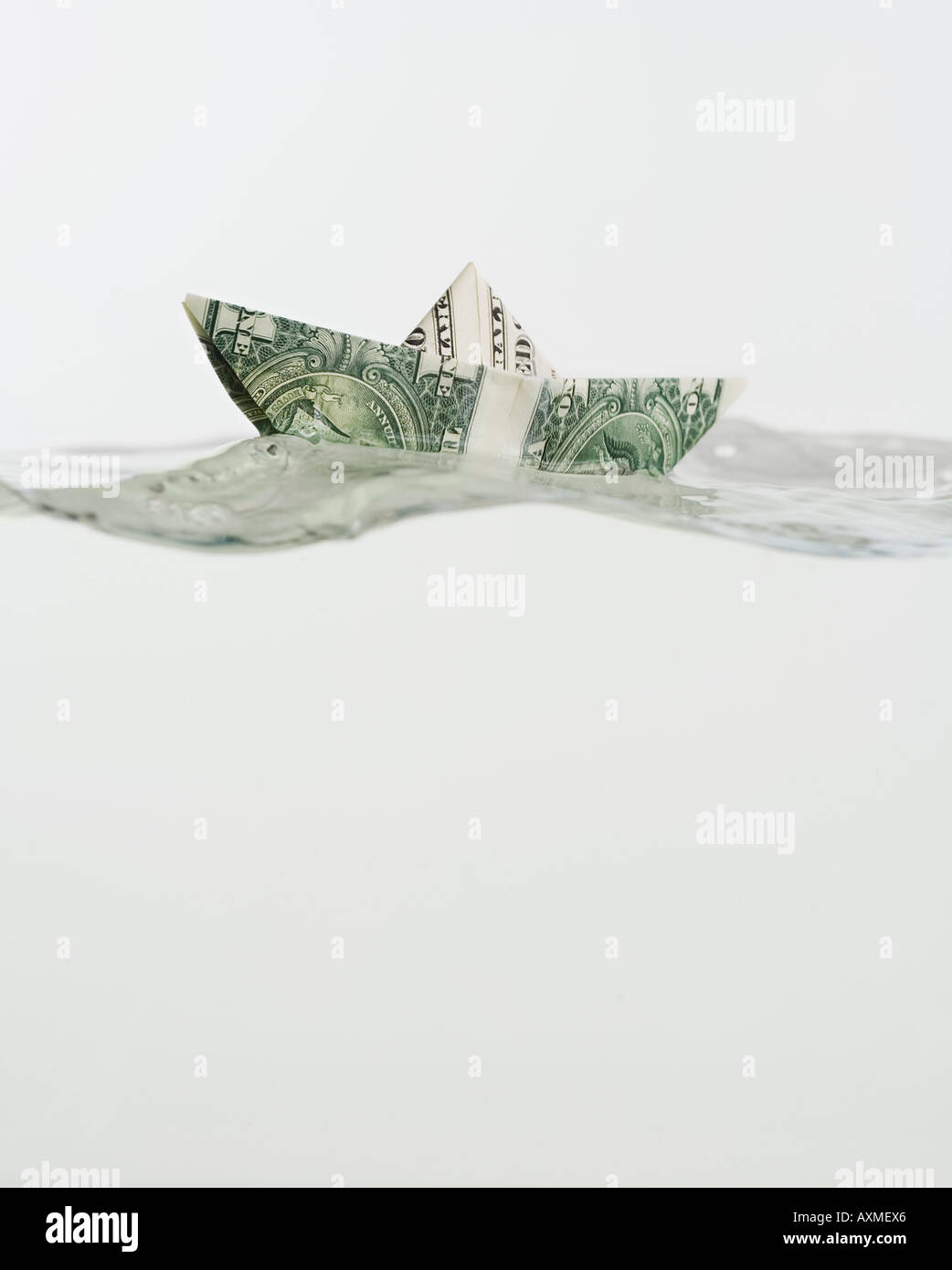 Boat made of US dollar floating on water Stock Photo - Alamy