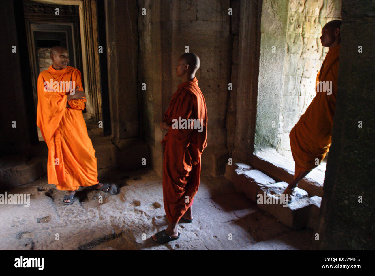 Novice monks relax among the temples of Angkor, Cambodia Stock Photo ...