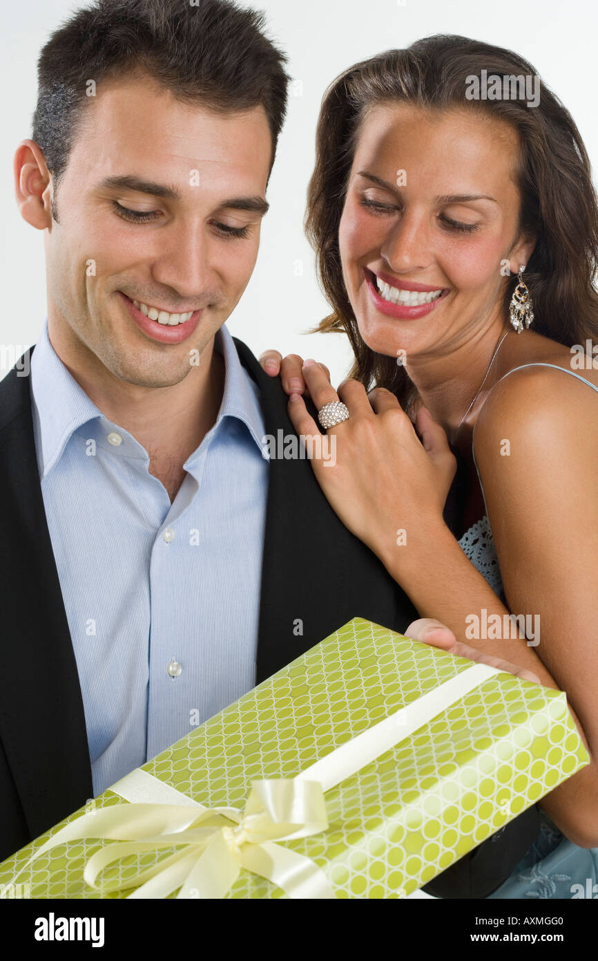 Woman giving man gift Stock Photo - Alamy