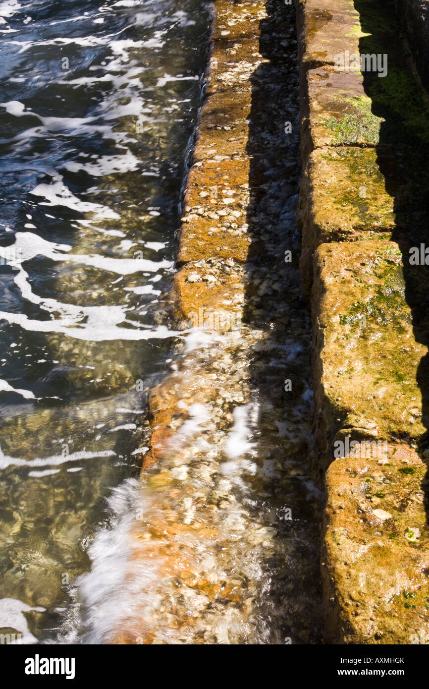 waves wash over sandstone steps Stock Photo - Alamy