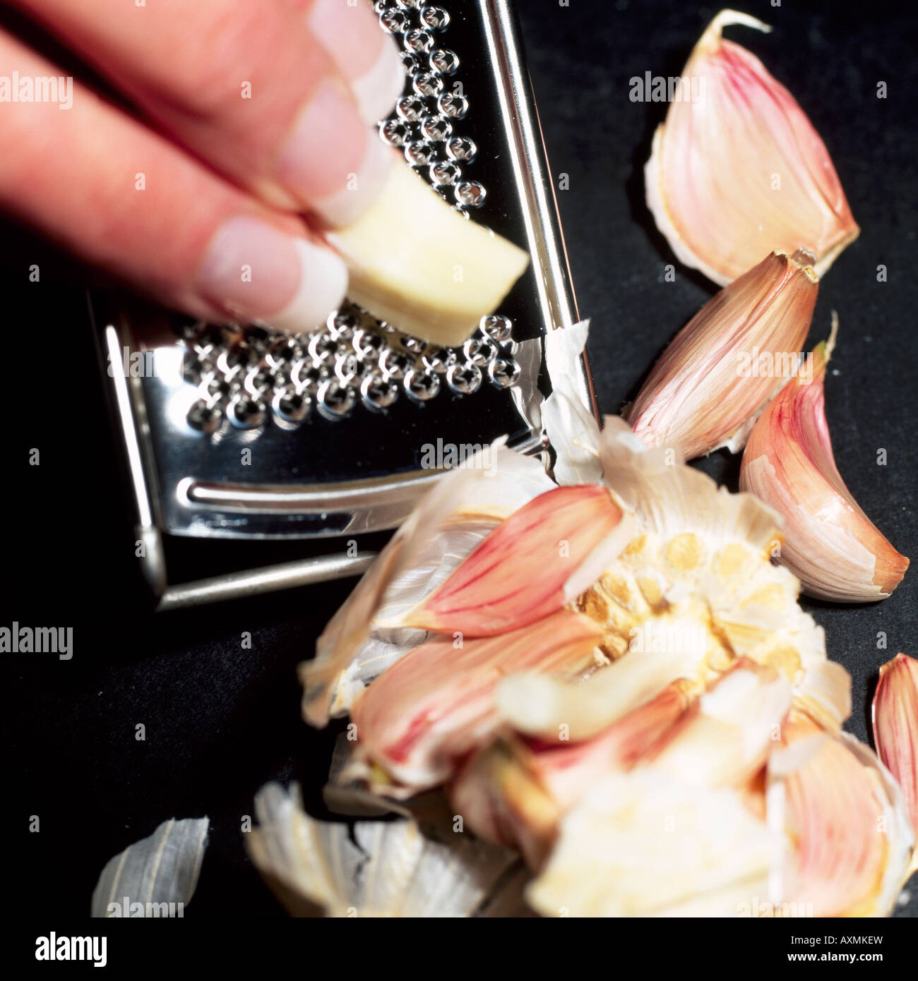 Woman Grating Garlic Stock Photo - Alamy