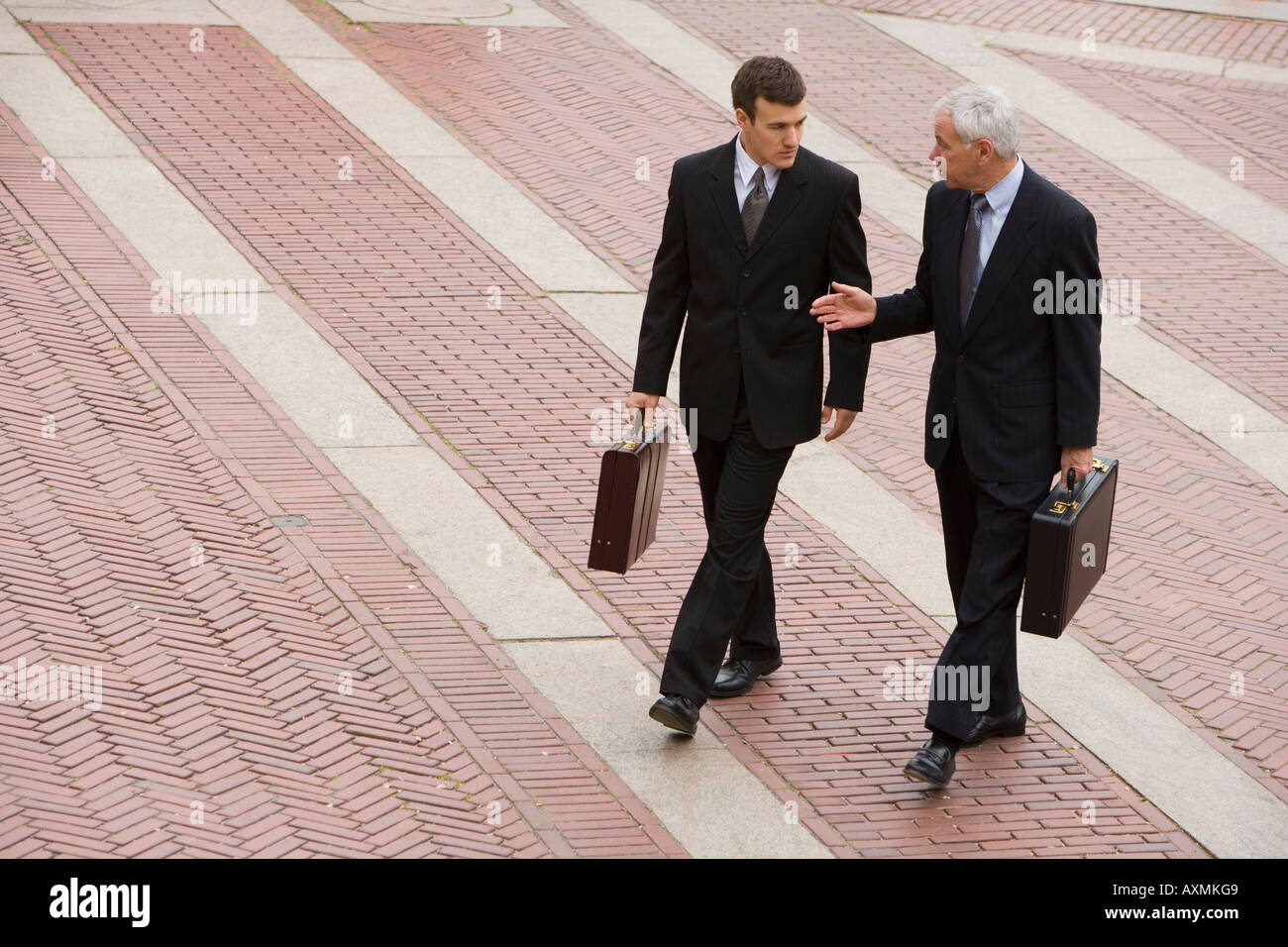Two professionals walking discussing hi-res stock photography and ...