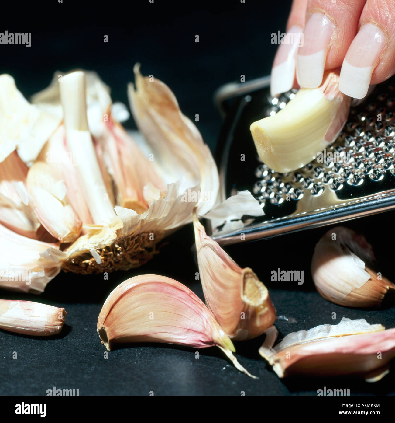 Woman Grating Garlic Stock Photo - Alamy