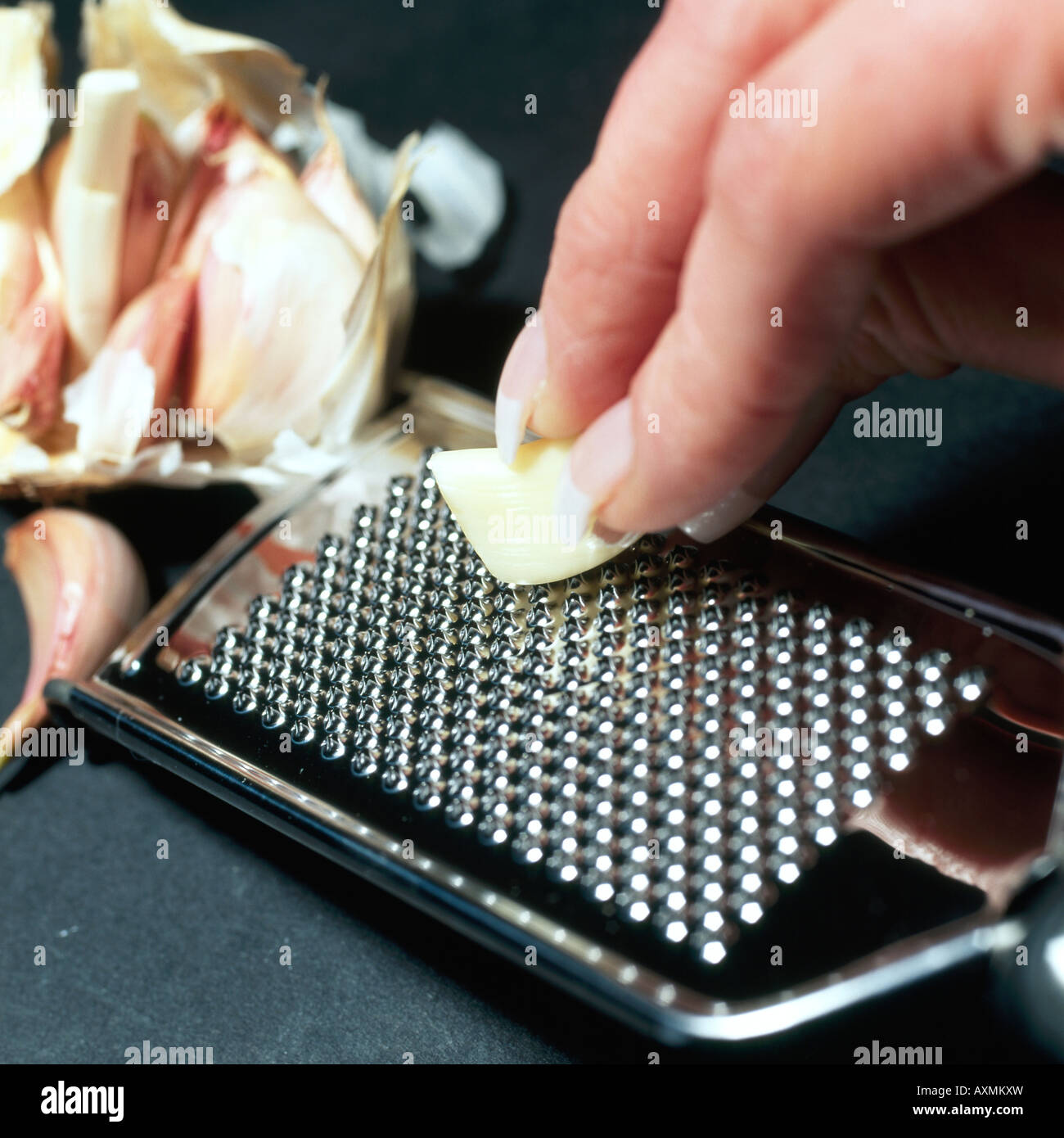 Woman Grating Garlic Stock Photo - Alamy