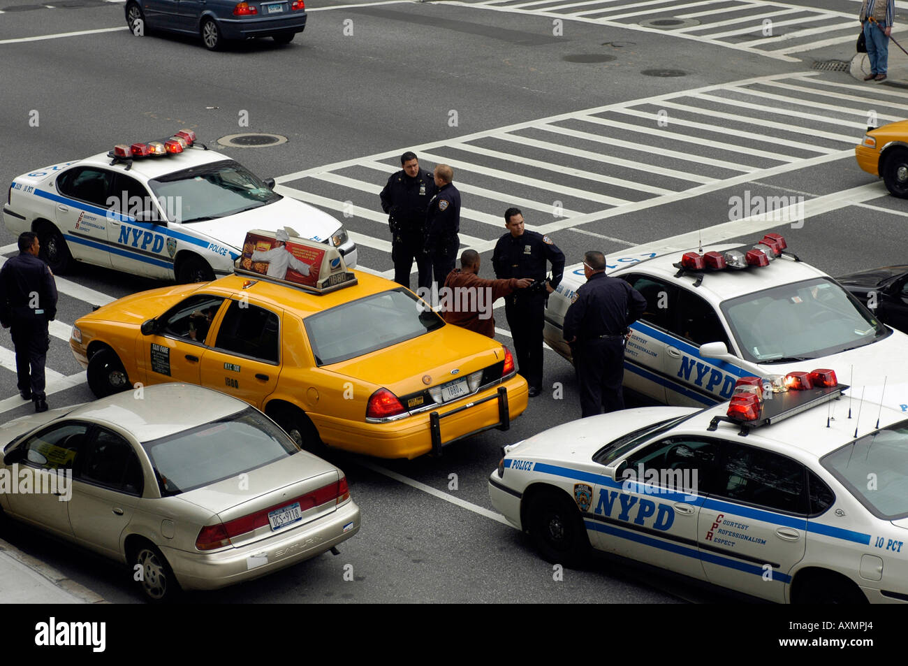 NYPD officers investigate altercation involving a taxi Stock Photo - Alamy