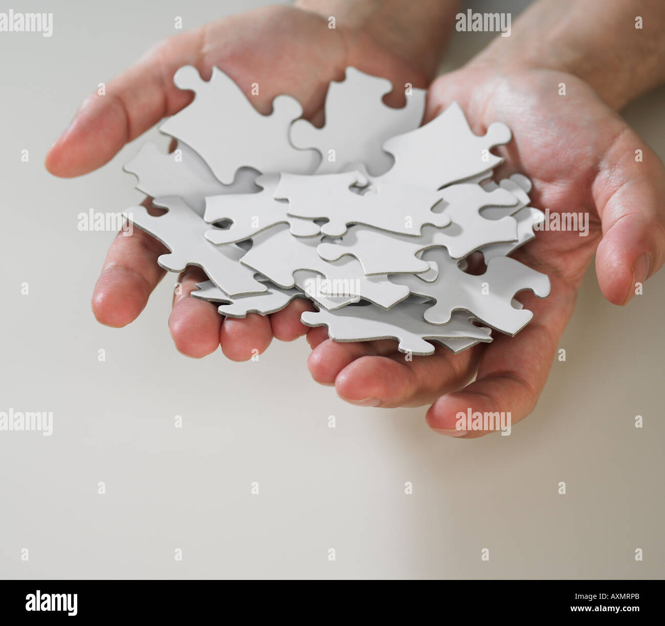 Hands holding puzzle pieces Stock Photo - Alamy