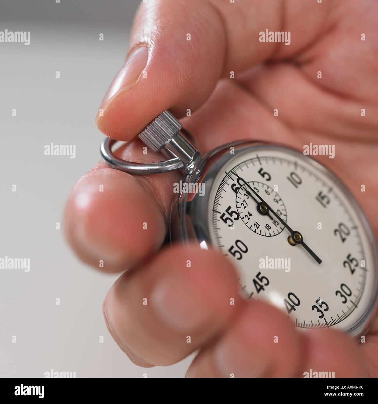 Hand holding stop watch Stock Photo - Alamy