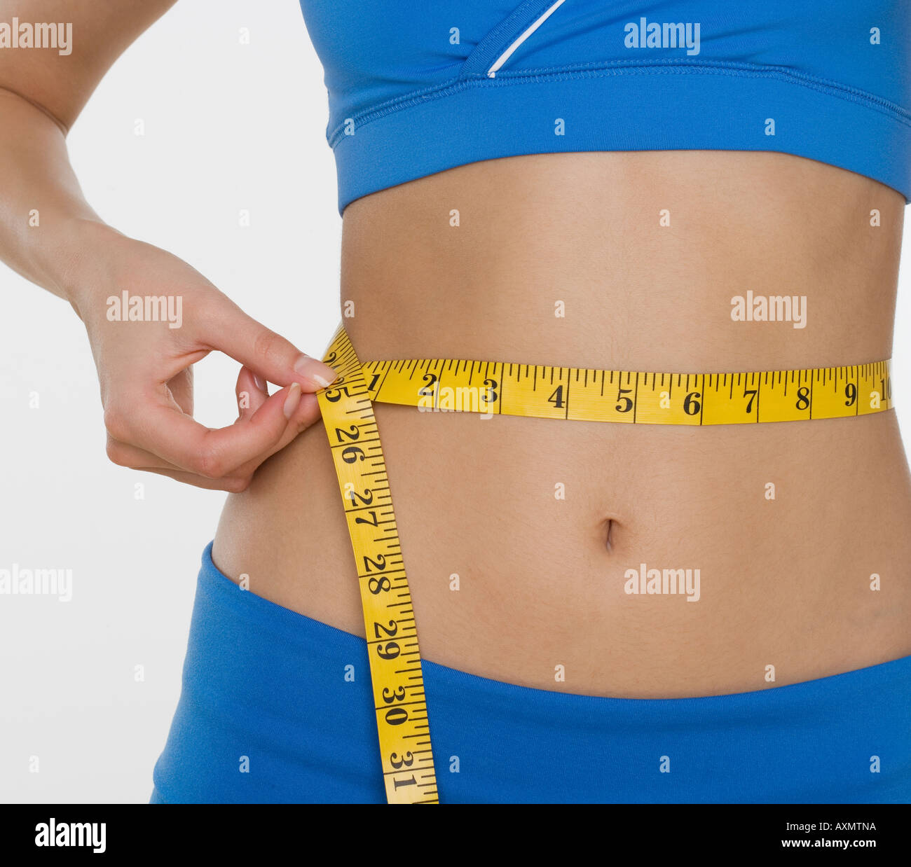 Young woman measuring her waist hi-res stock photography and images - Alamy